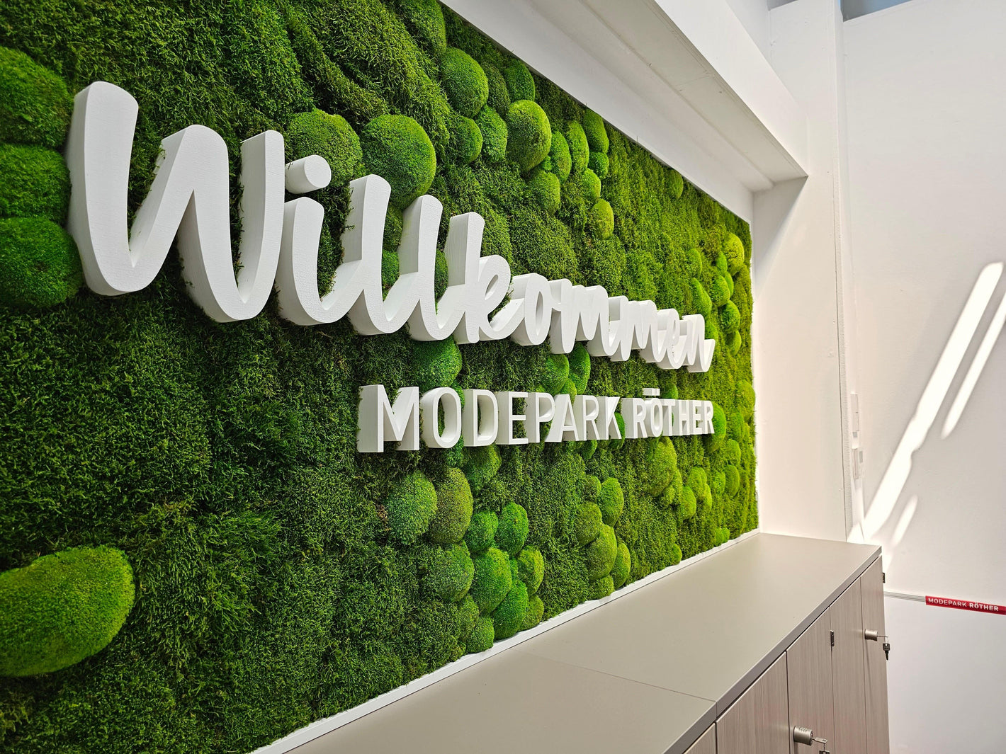 Mooswand mit Logo: Markenpräsenz trifft Naturdesign